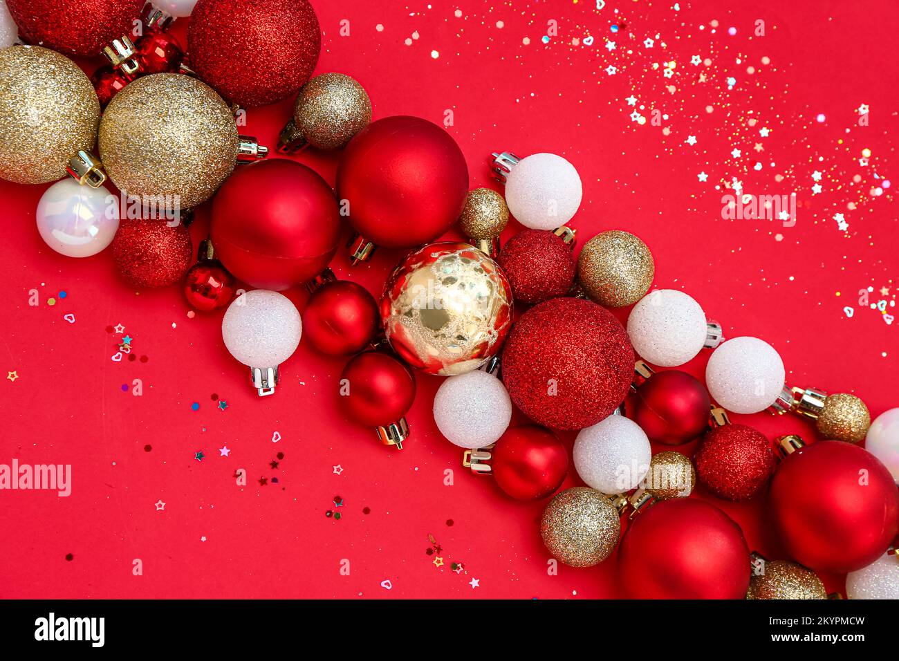 Christmas balls with sequins on red background Stock Photo - Alamy