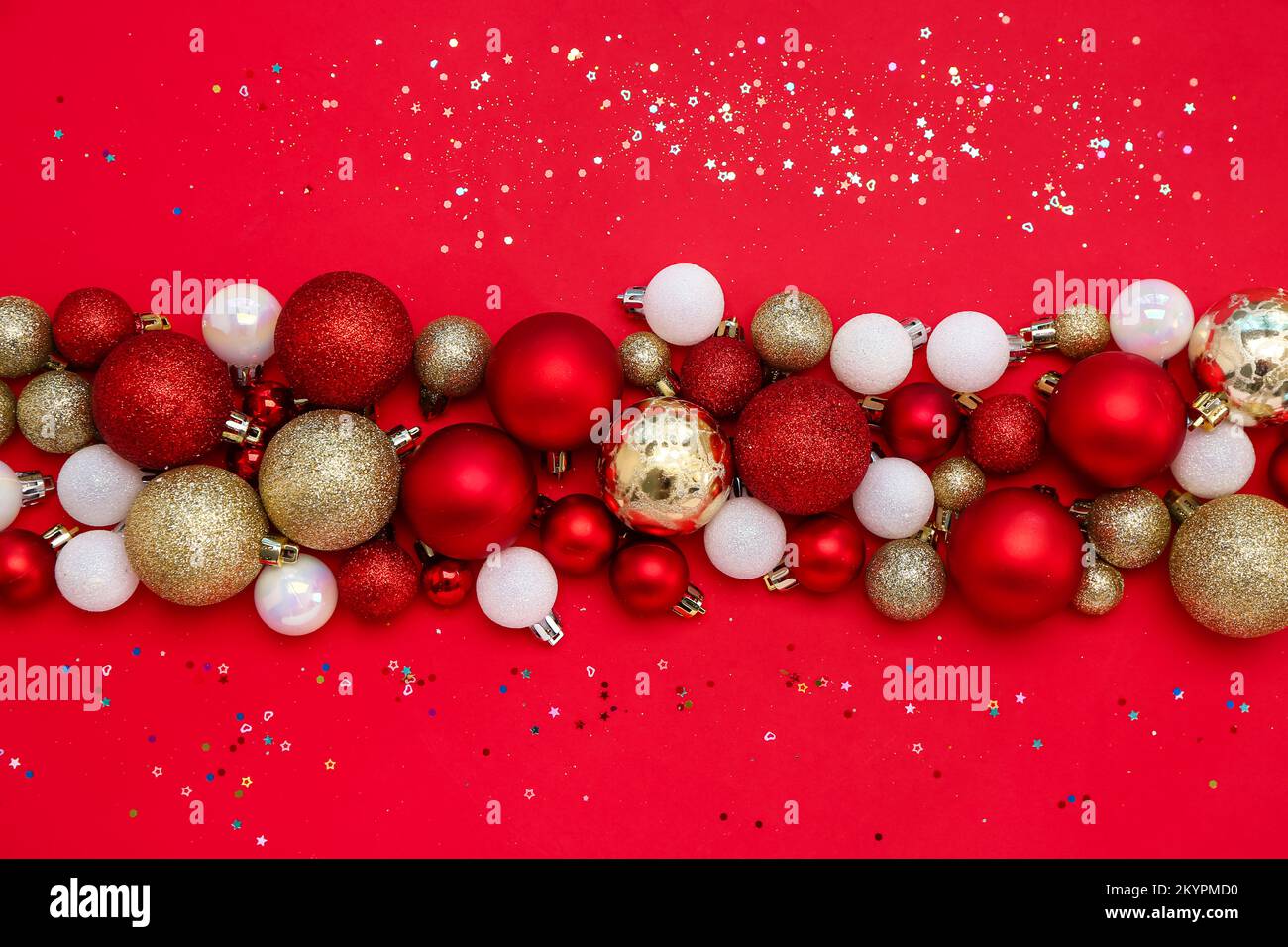 Christmas balls with sequins on red background Stock Photo - Alamy
