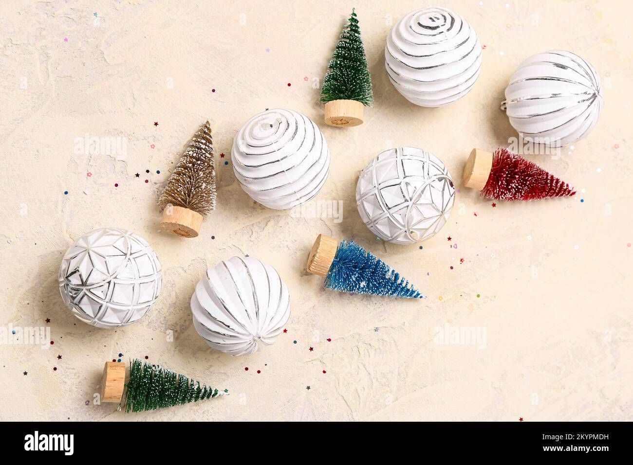 Christmas balls with fir trees on light background Stock Photo - Alamy
