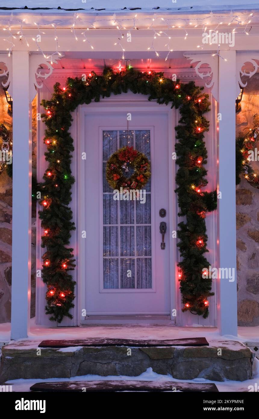 Illuminated front entrance door of two storied fieldstone Canadiana ...