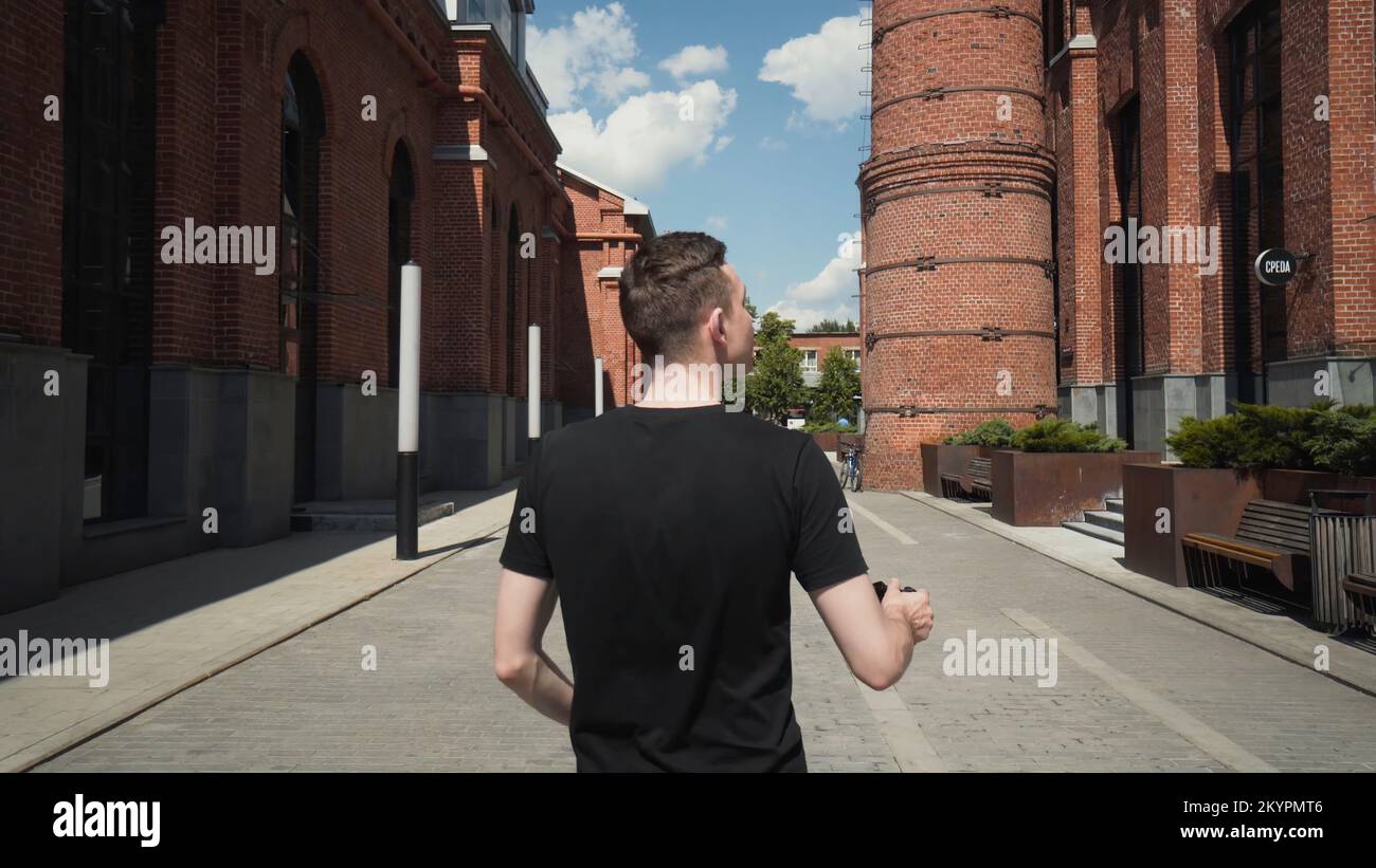 Young man takes pictures of beautiful buildings. Action. Guy takes ...