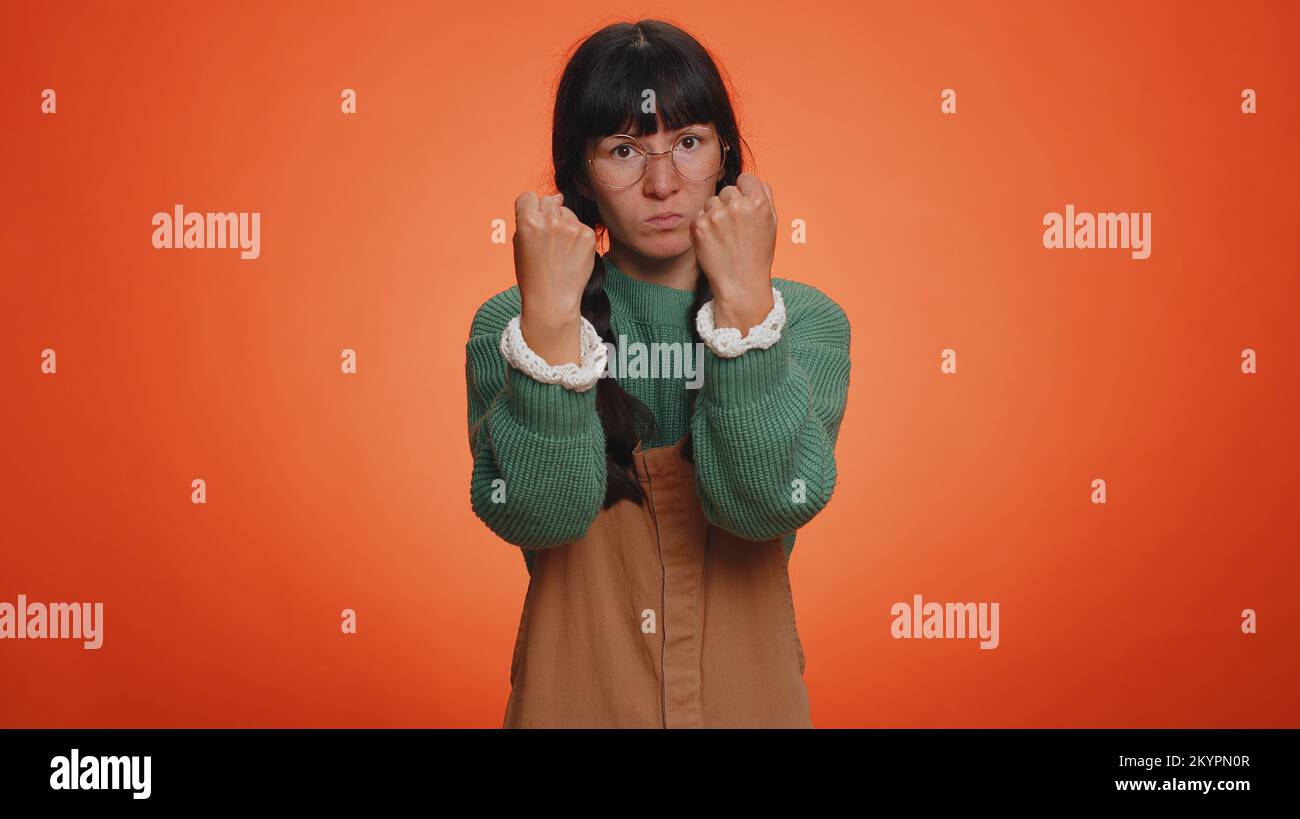 Aggressive millennial woman making fight threat at camera, shaking fist ...