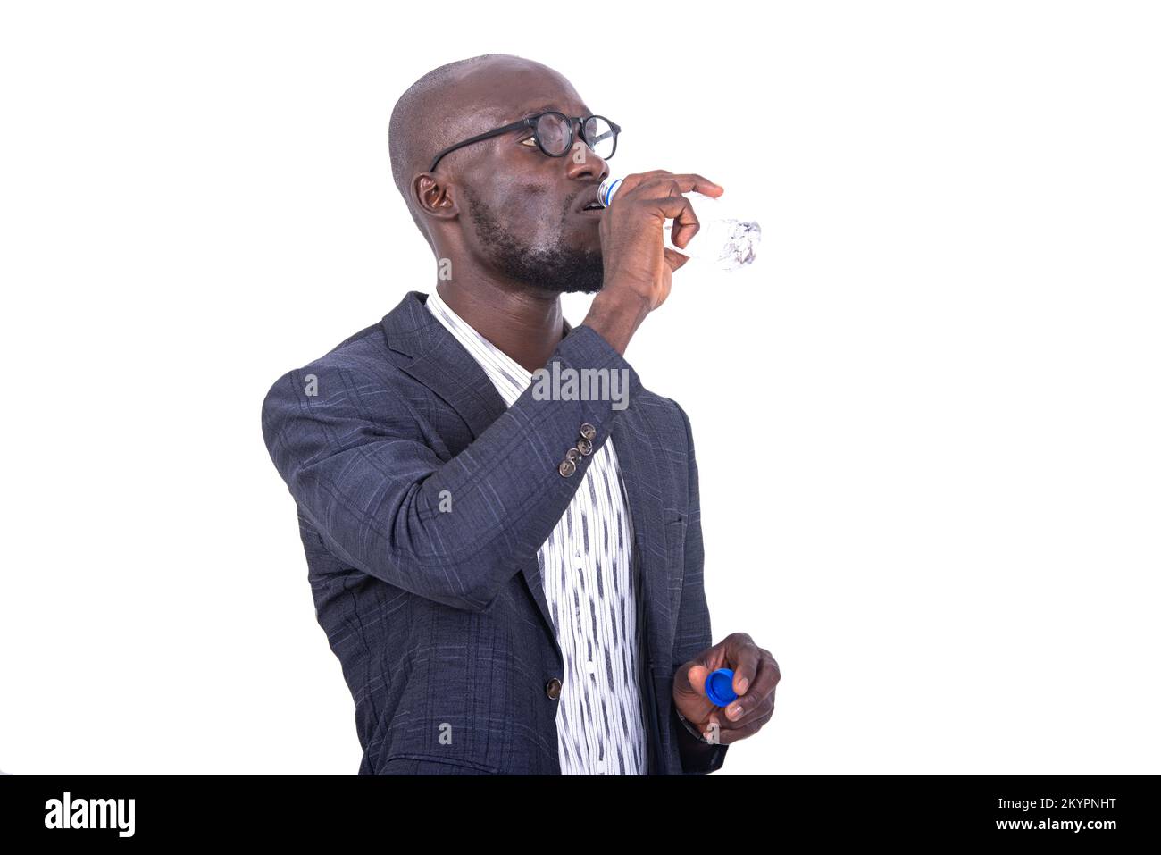 portrait of a serious adult businessman drinking water from a plastic ...