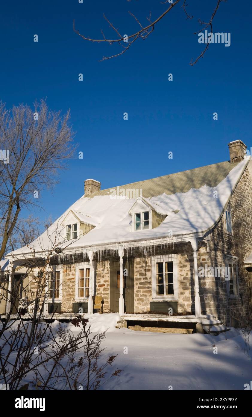 Old 1700s two story Canadiana style fieldstone home through trees in ...