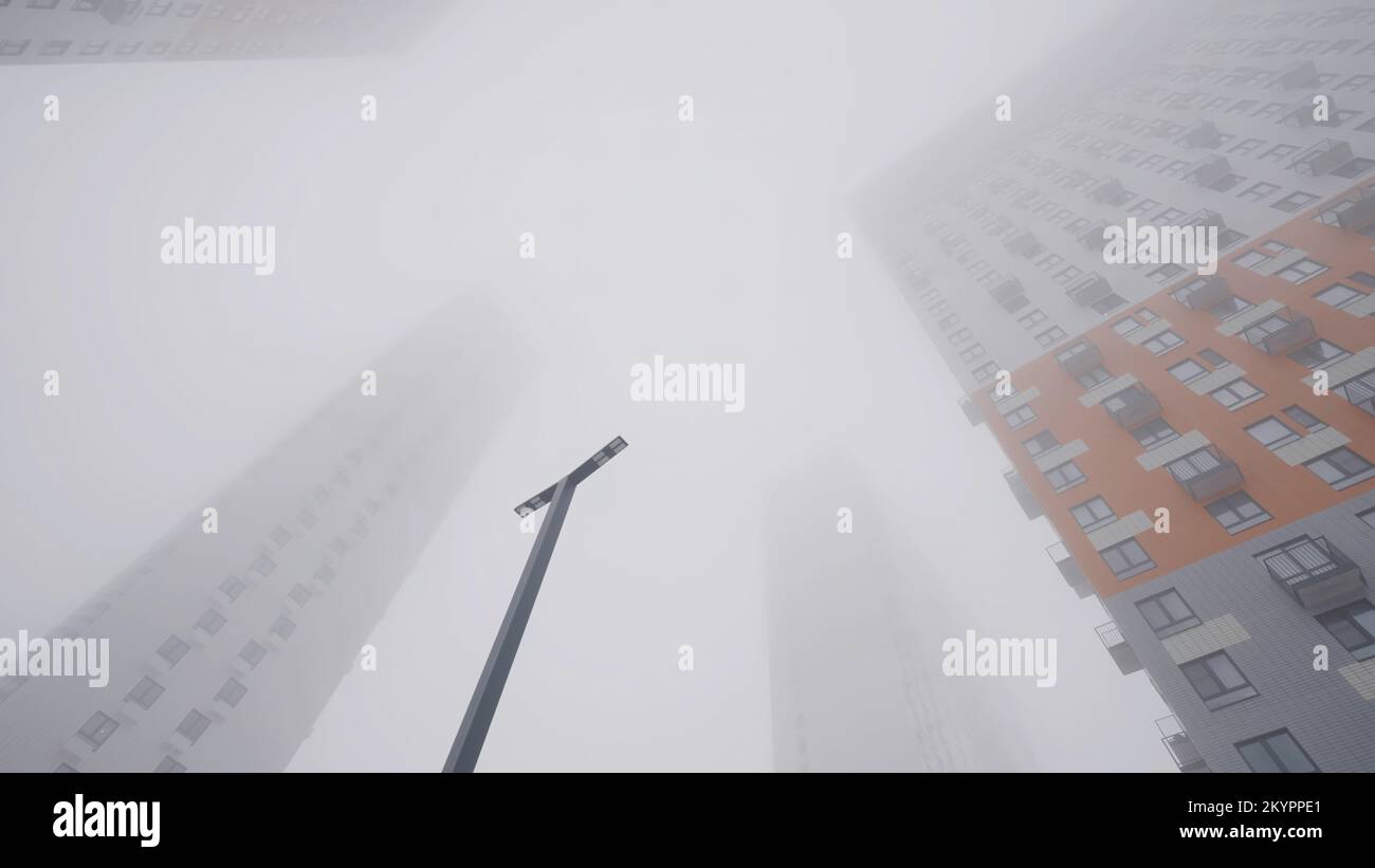 Residential high-rise buildings in fog. Action. Bottom view of high ...