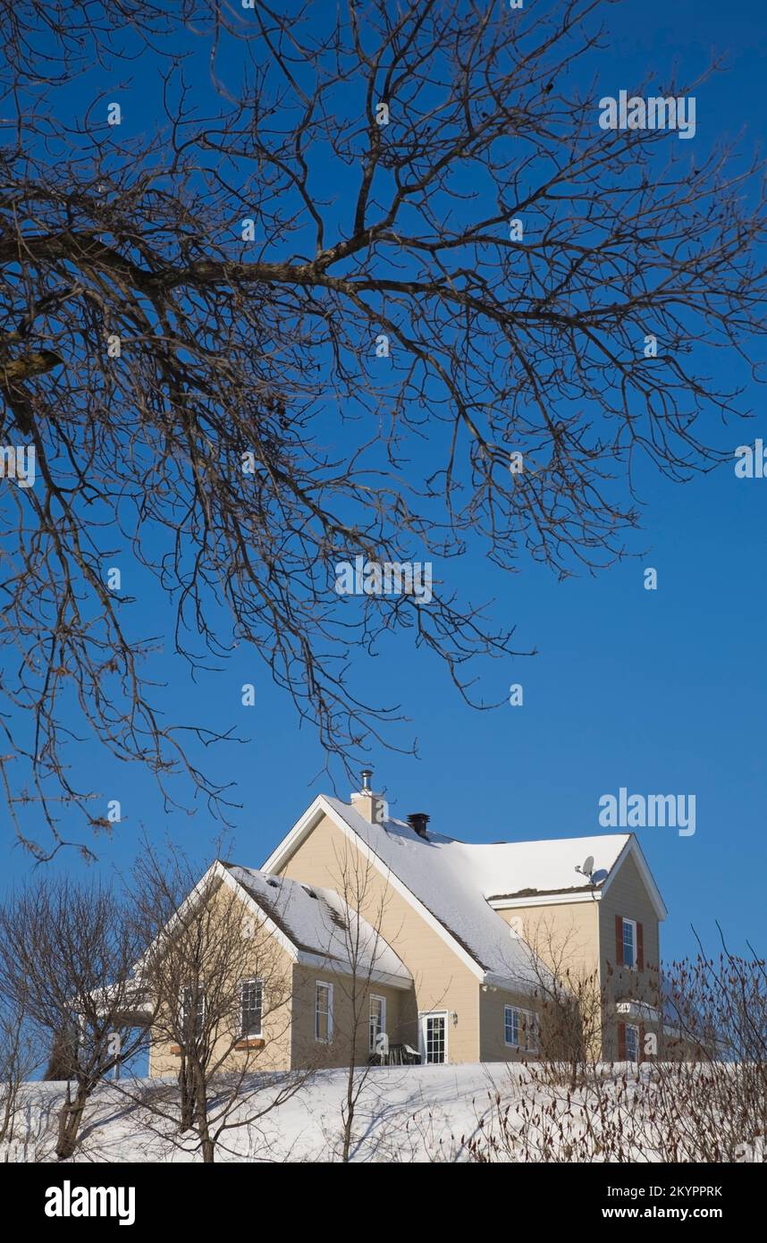 Two story beige with white trim country style home on a hilltop in ...