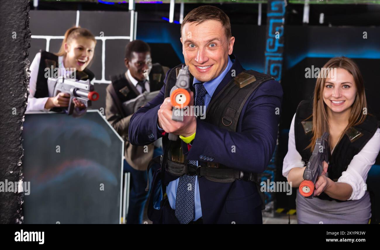 Man holding laser gun and playing laser tag Stock Photo - Alamy