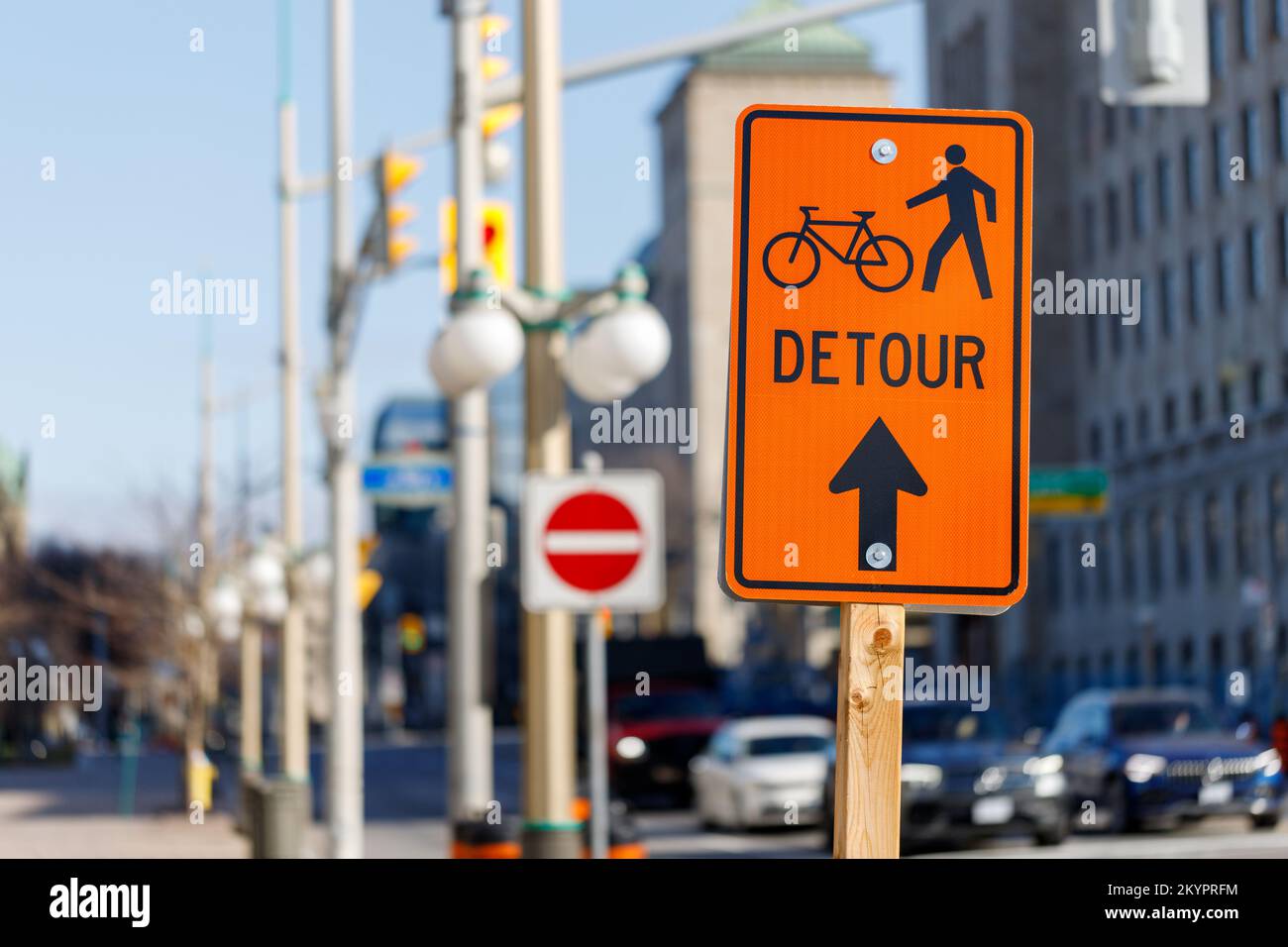 Orange detour sign for bikes and pedestrians. Closed way for bikes and ...