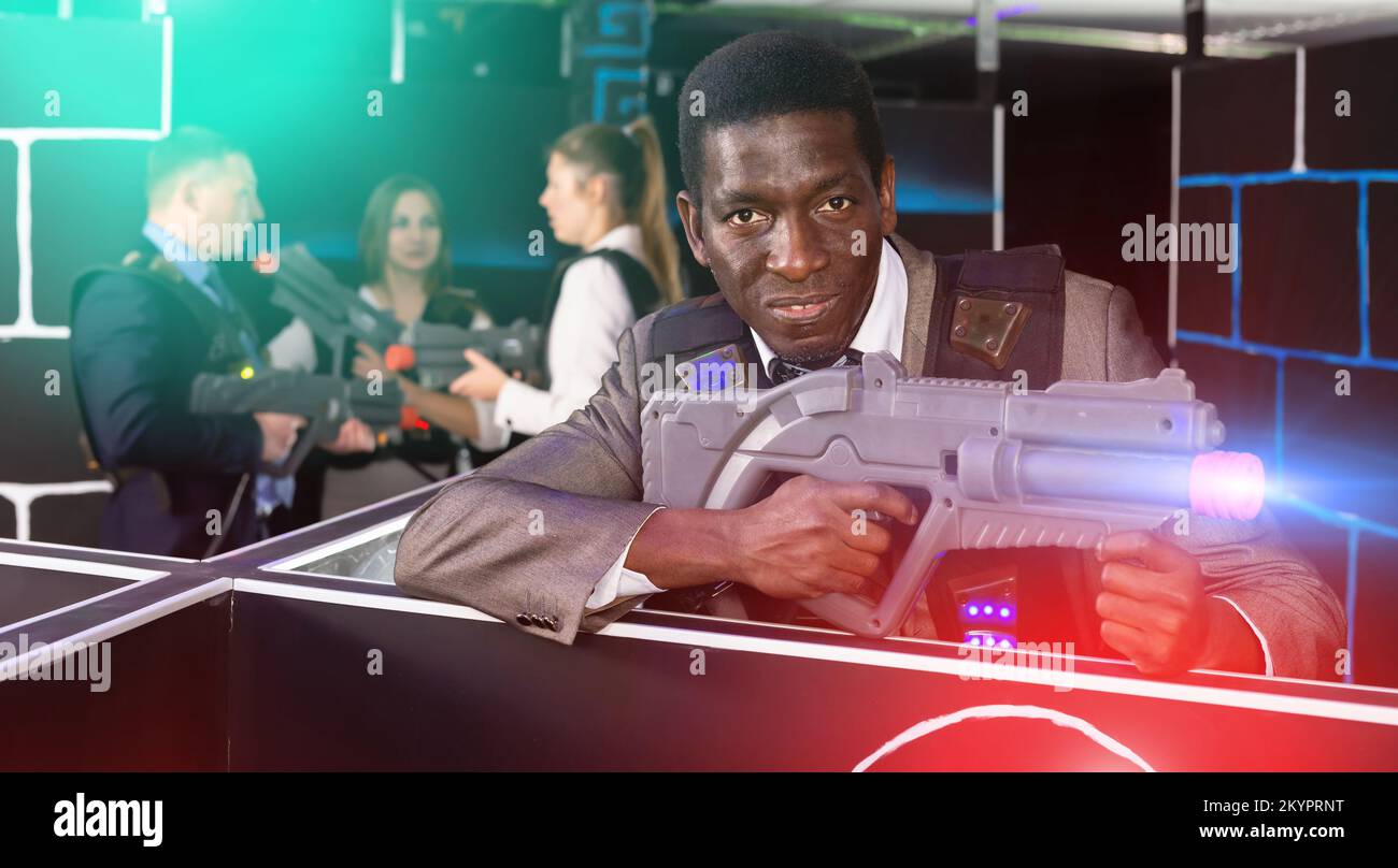 Happy Afro man and colleagues in laser tag room Stock Photo - Alamy