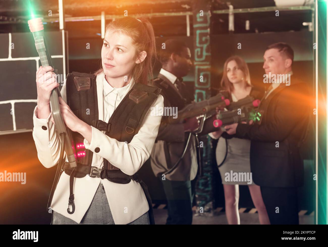 Woman holding laser gun and playing laser tag Stock Photo - Alamy