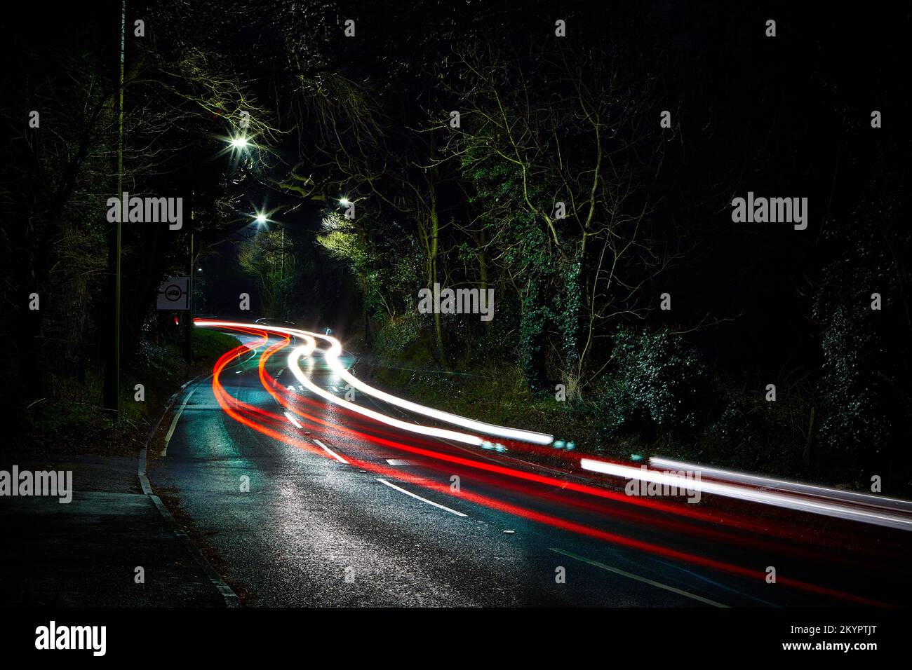 Symmetrical light trails. Long exposure night shot during rain with ...