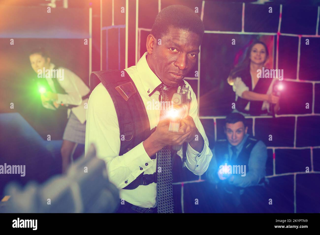 Afro businessman playing laser tag Stock Photo - Alamy