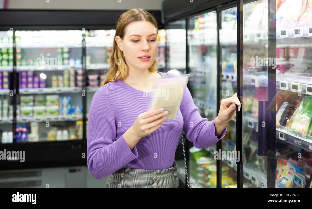 woman chooses cheese Stock Photo - Alamy