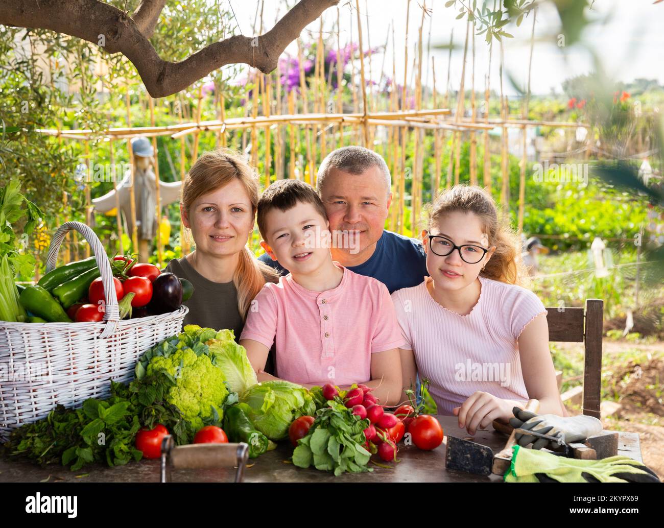 Family posing in garden with picked vegetables Stock Photo - Alamy