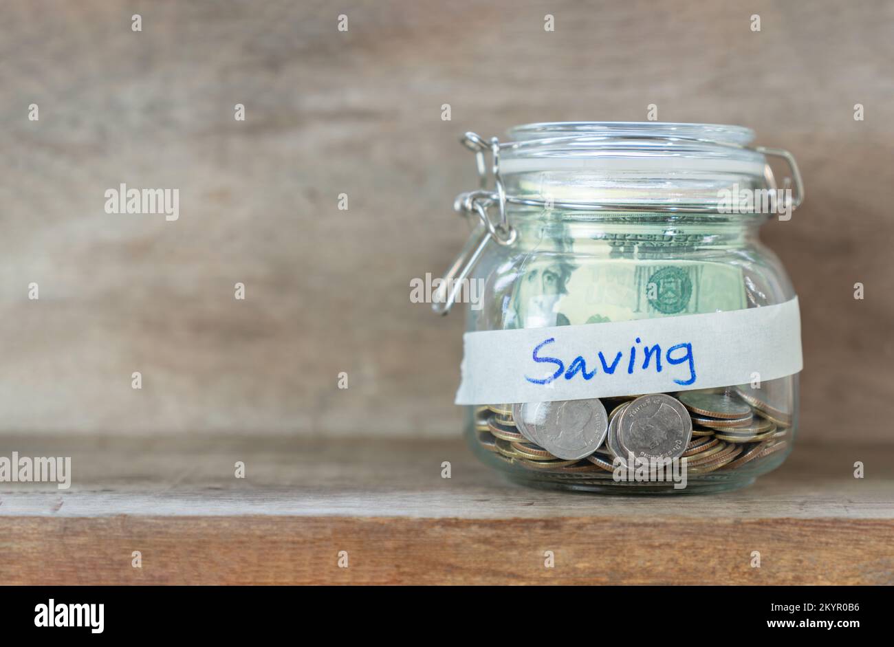 Concept of saving or invesment dollar bills and coin in glass jar on ...