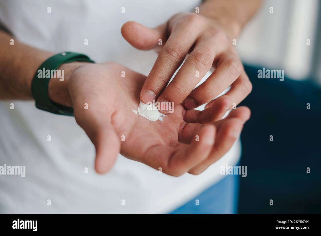 Close-up man's hands rubbing cream in the palm of his hand. Health ...