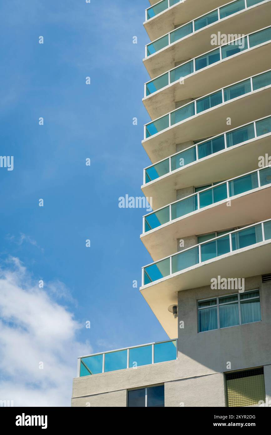 Low angle view of corner of a building with glass railings on balconies ...