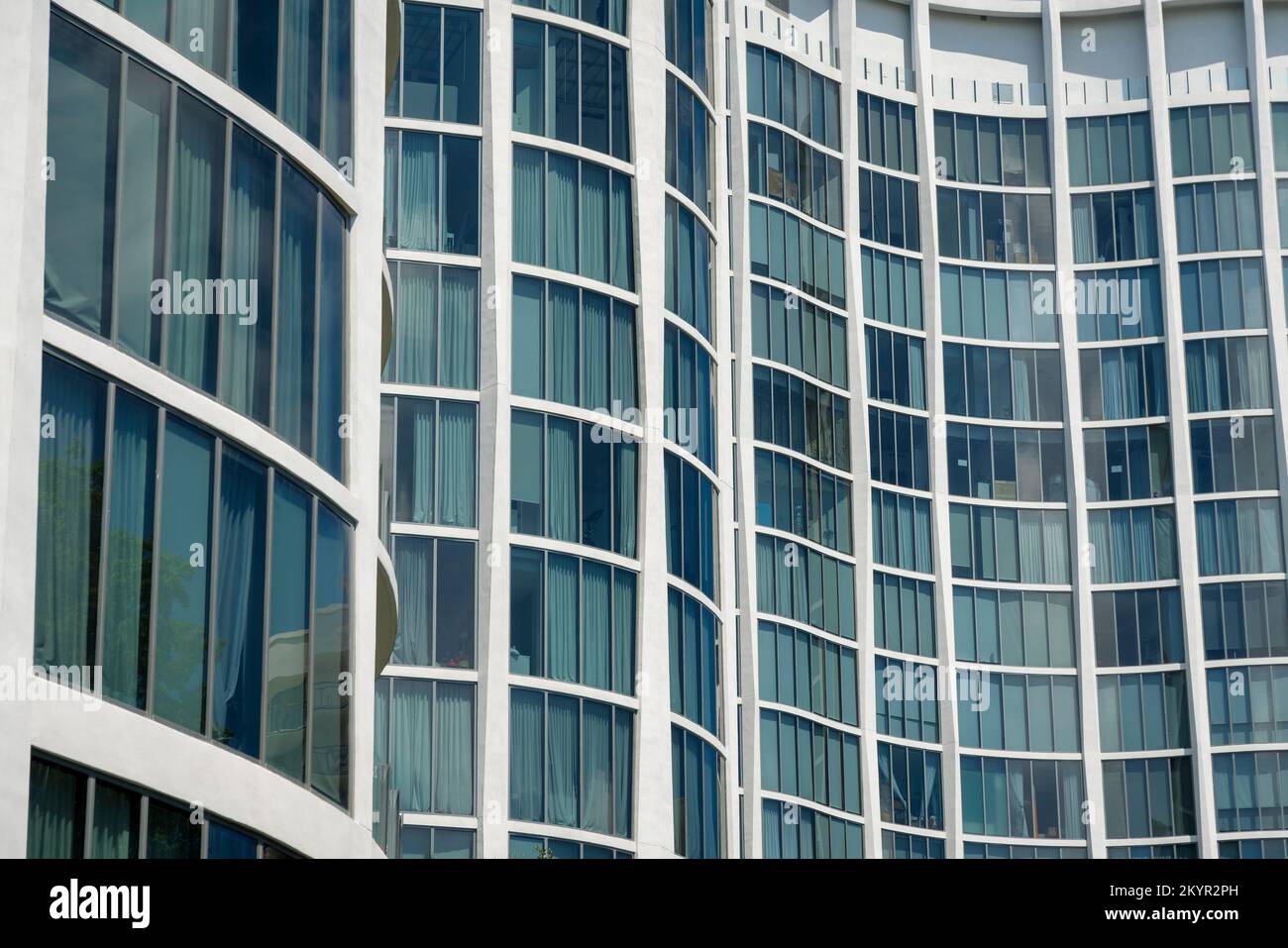 Close-up of a modern building exterior with curved walls with tall ...