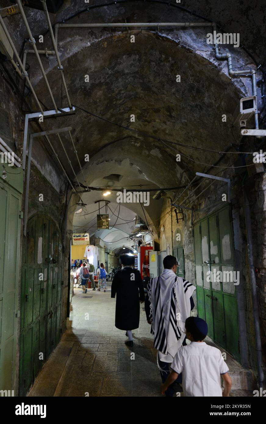 Religious Jewish men walking through the Muslim quarter in the old city ...
