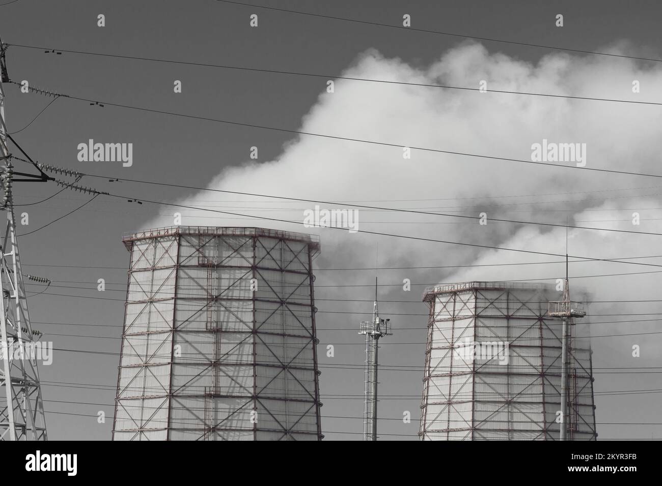 Toxic grey smoke is released from the cooling tower into the atmosphere ...