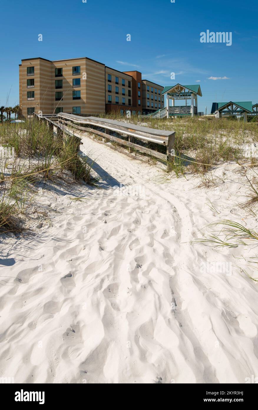 Path on sand heading to a boardwalk in the middle of sand dunes at the ...