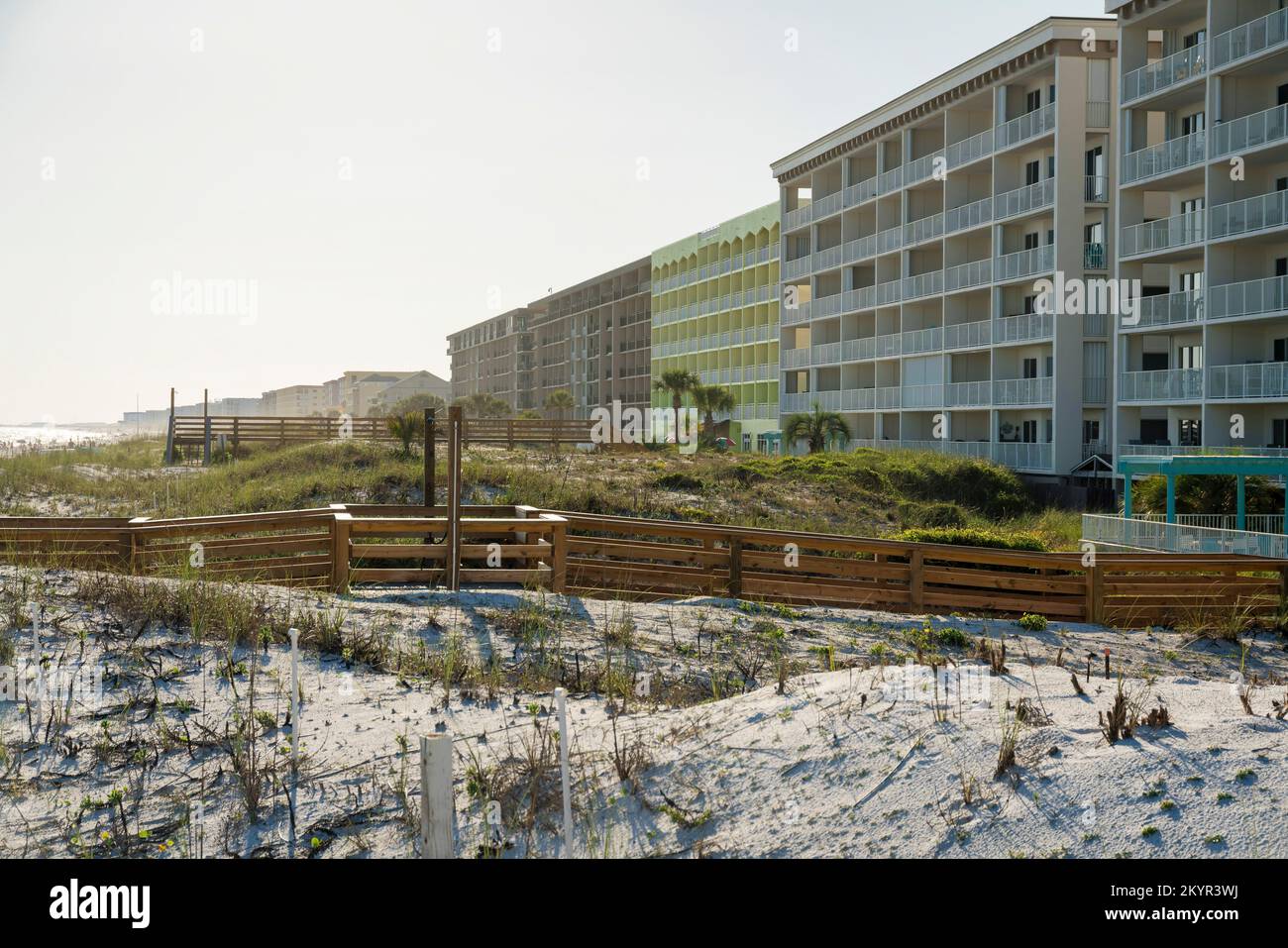 Hotel buildings with wood pathways on a white sand dunes outdoors in ...