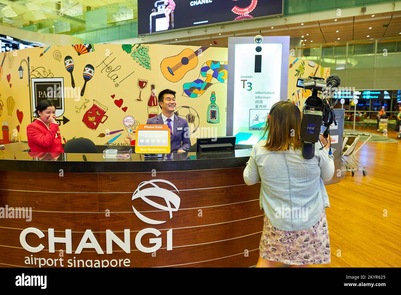 SINGAPORE - NOVEMBER 03, 2015: woman with camera near information desk ...