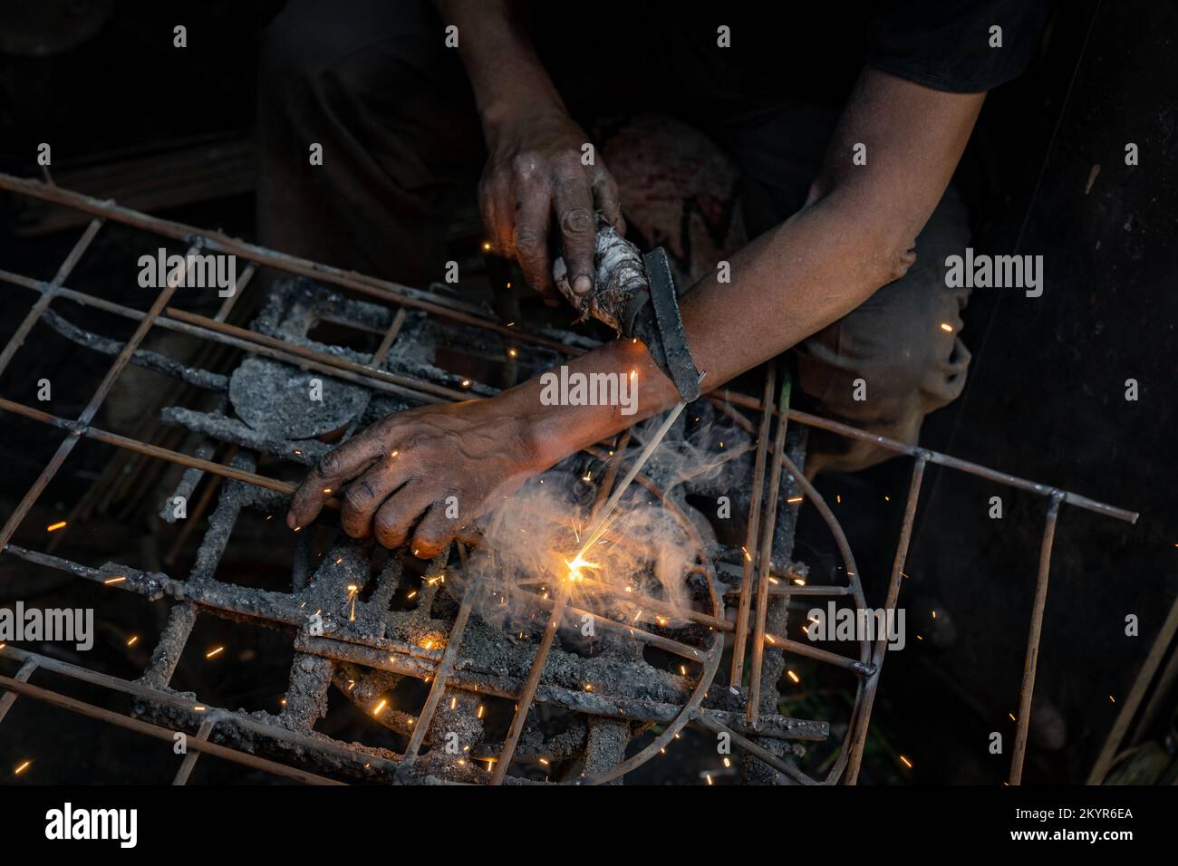 Metal worker soldering a grill together with sparks in the Marrakech ...