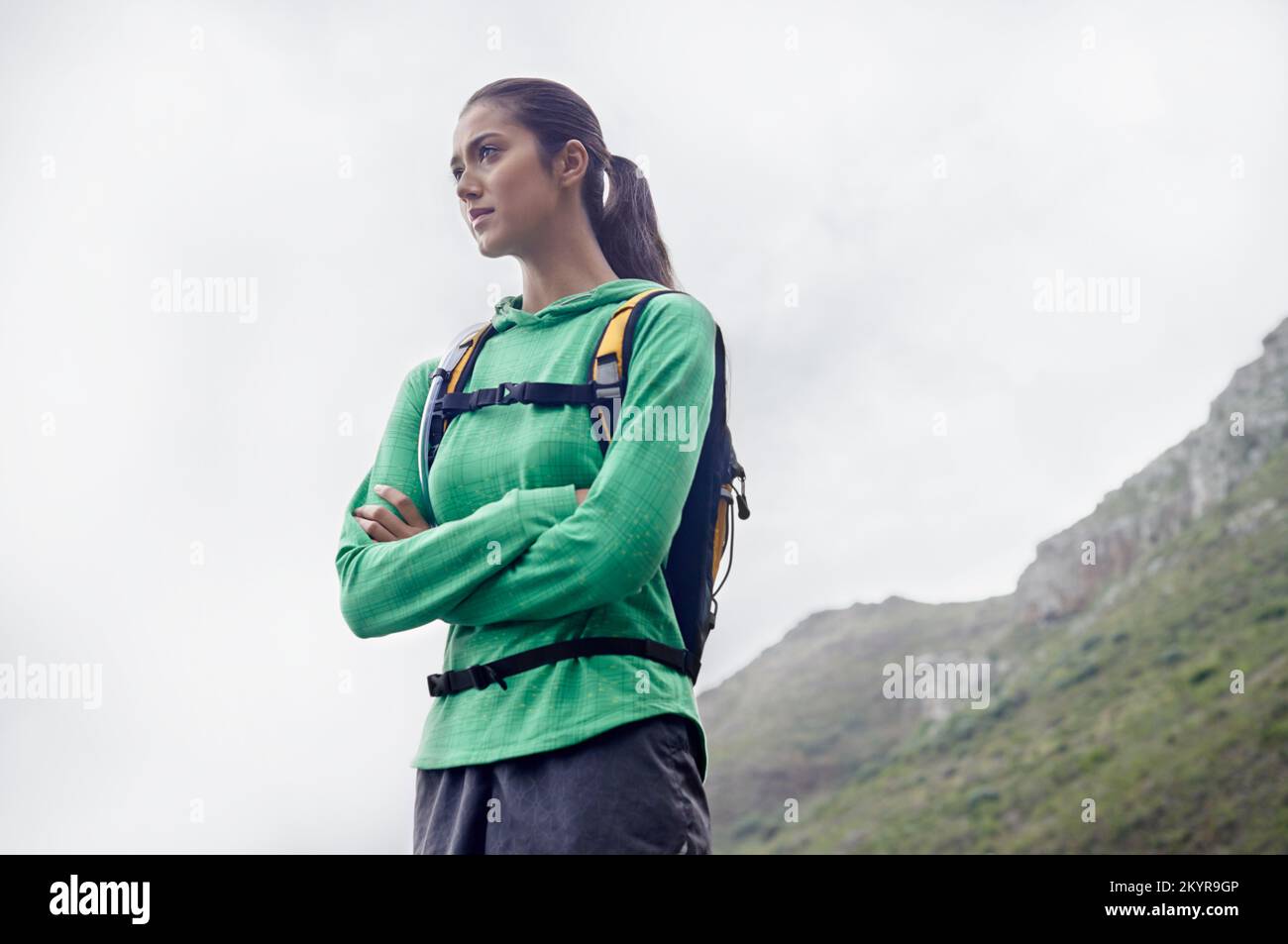She loves trail running. A beautiful young woman standing against a ...