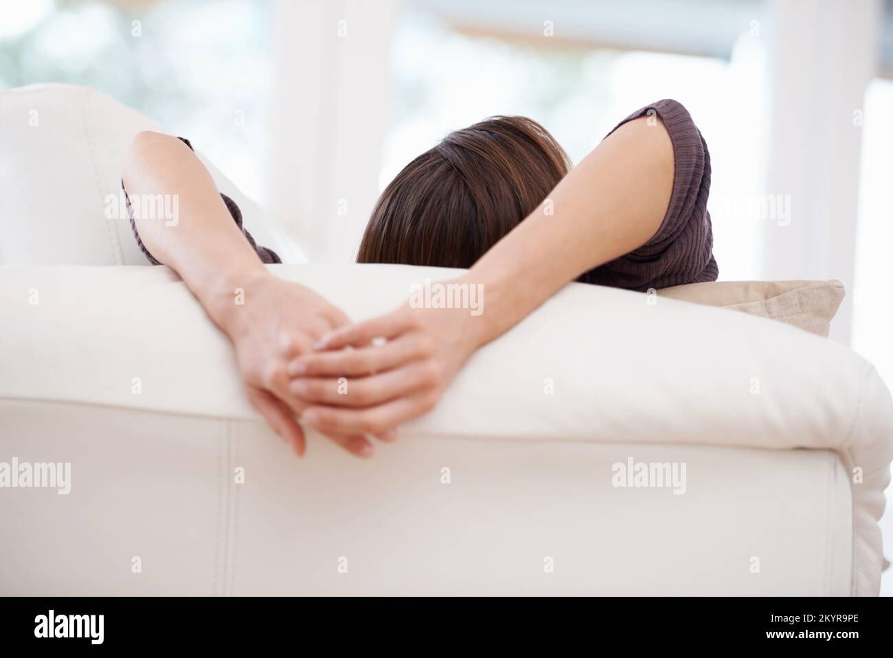 Complete relaxation. Rear-view of a woman relaxing on her couch Stock ...
