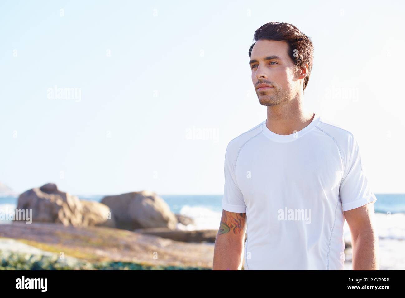 Getting back to nature. a young man enjoying a day at the ocean Stock ...