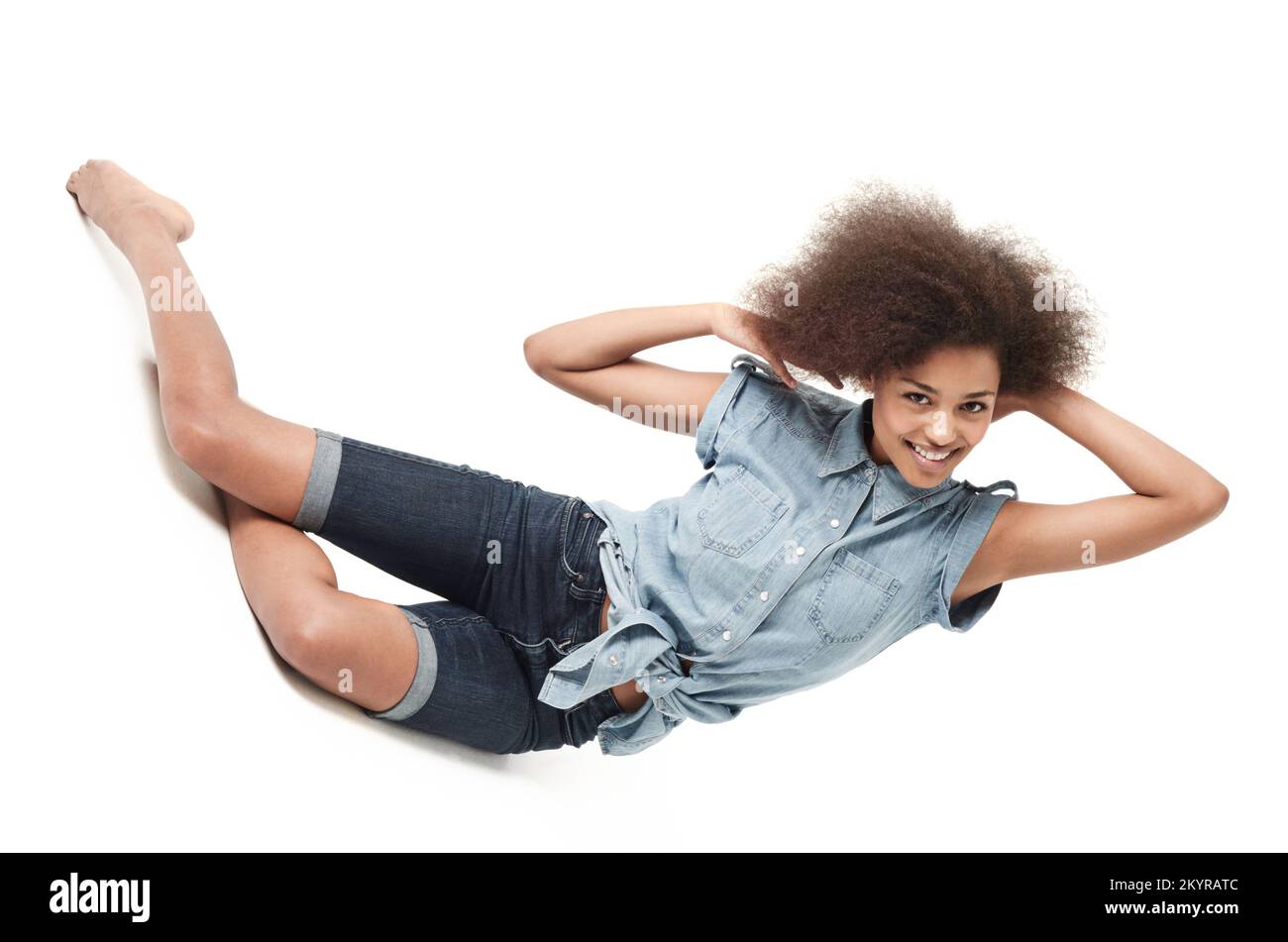 Striking an unusual pose. Young african american woman smiling while ...