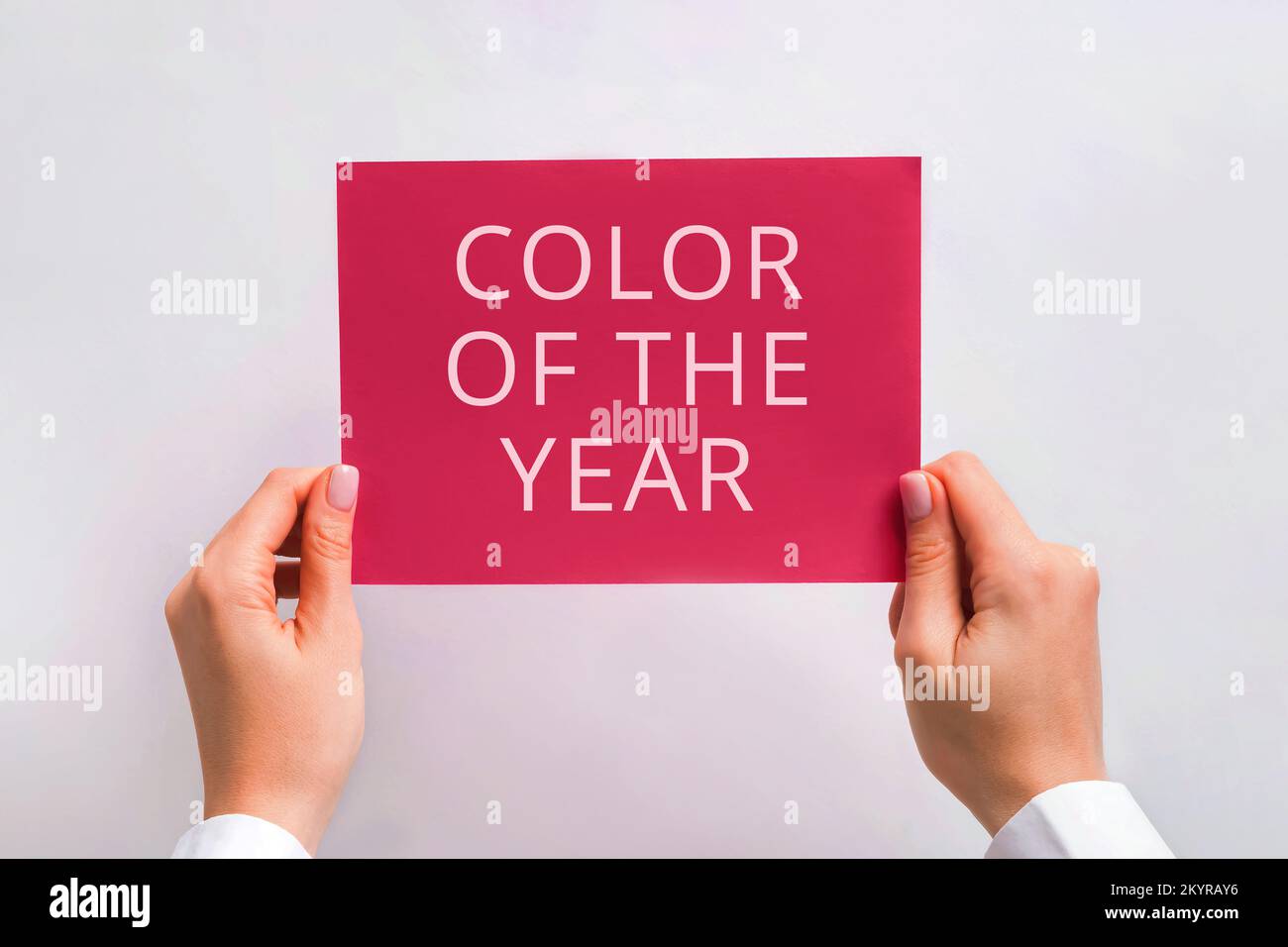 Woman holding paper of vivid magenta color. Color of the year 2023 ...