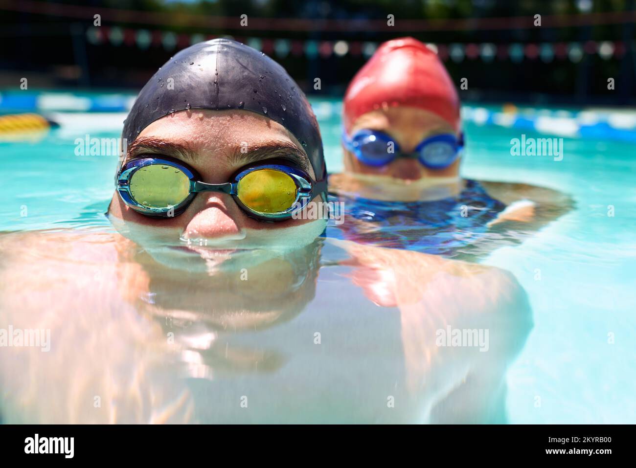 Were at home in the water. Two young swimmers with their faces half ...