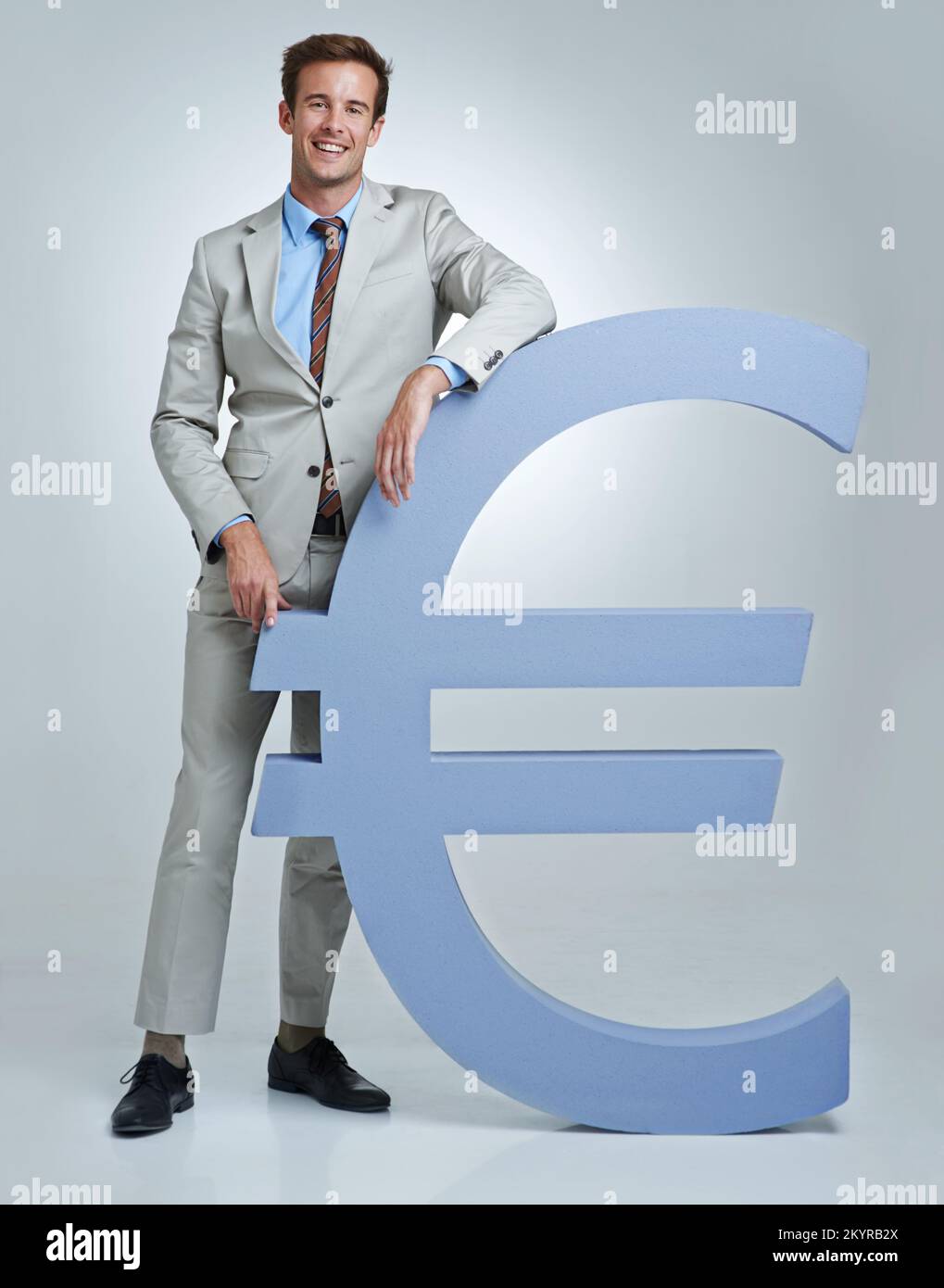 Standing strong with the Euro. Portrait of a young businessman standing ...