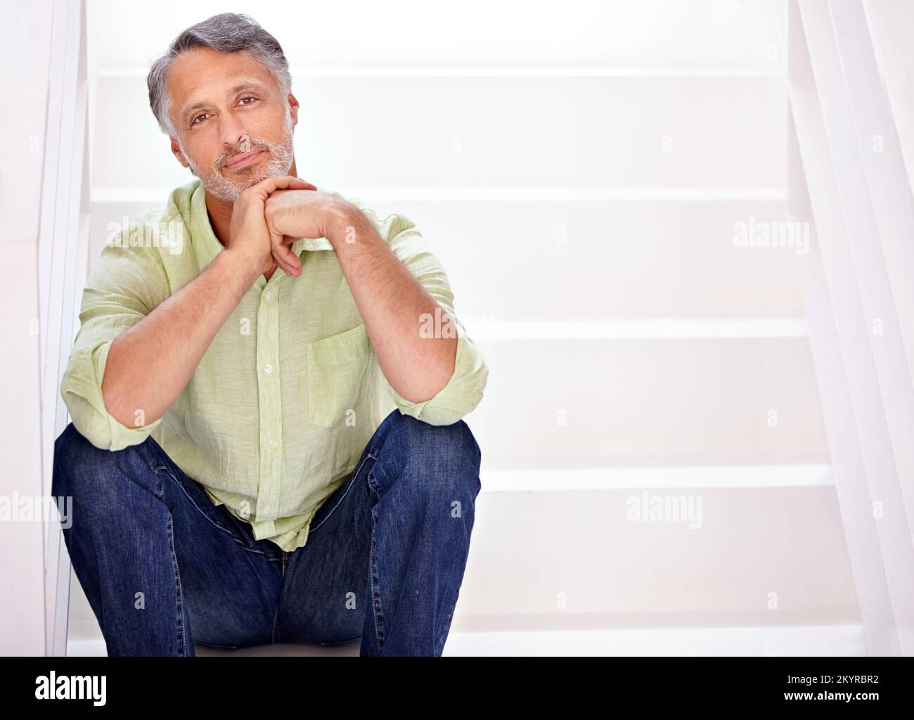 Hes got great workplace confidence. A handsome mature man sitting on a ...