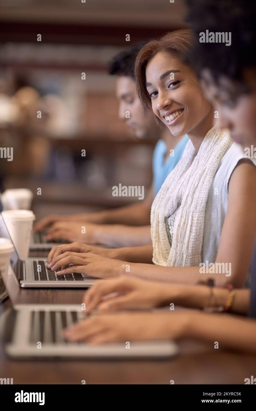 Working towards a bright future. A group of students using a laptop to ...