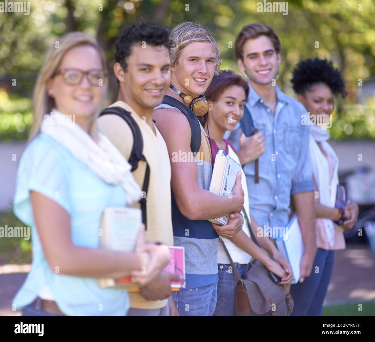 Excited about college. Portrait of a group of students standing in a line on campus Stock Photo ...