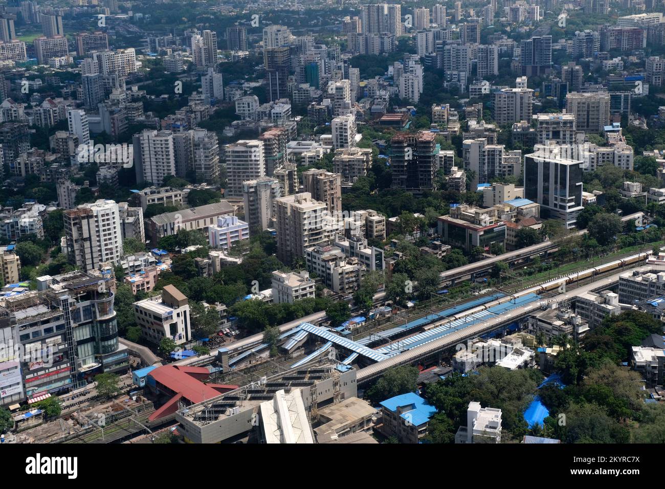 An aerial view of Mumbai's skyline passing over a building with roads ...