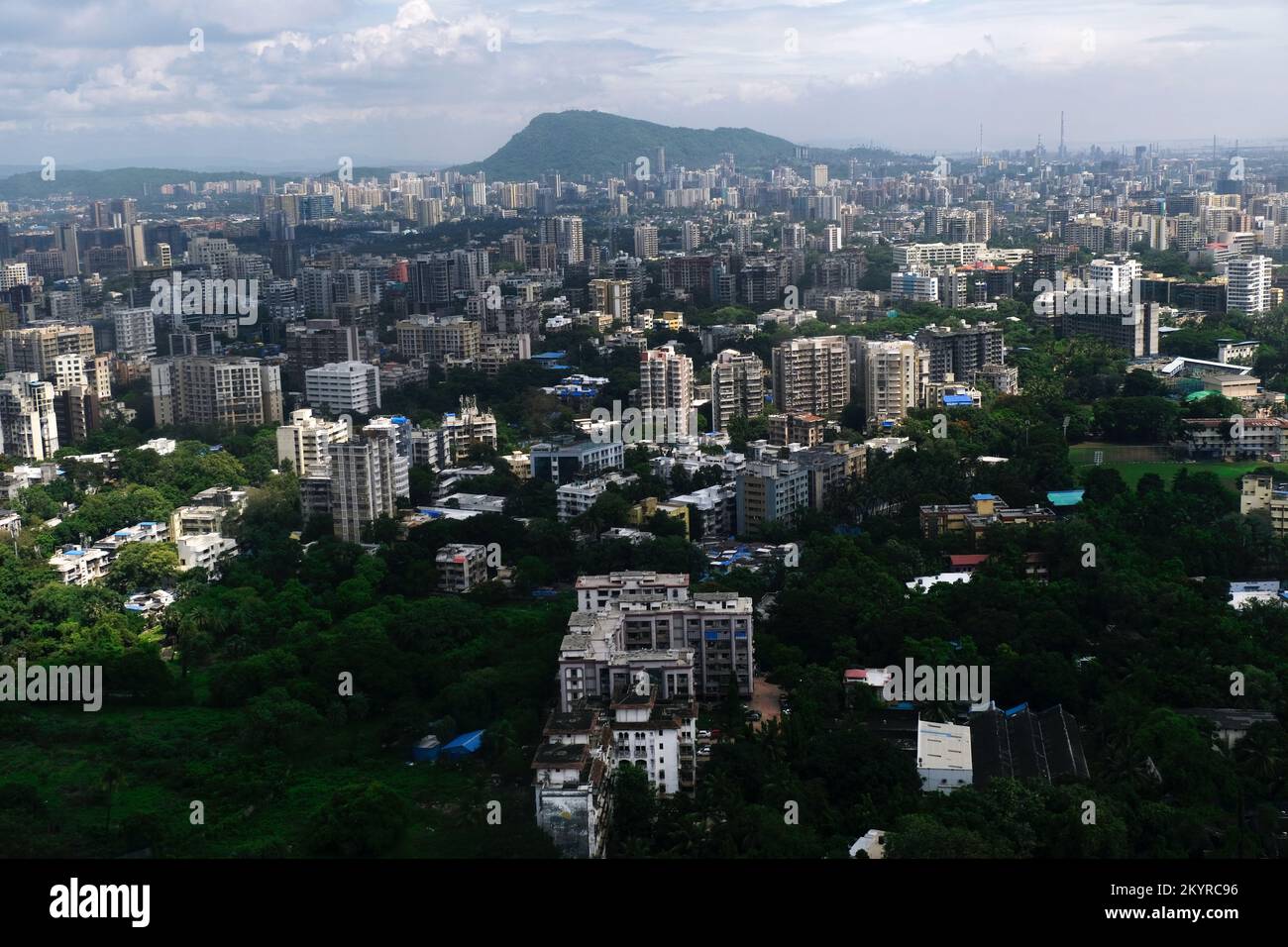 An aerial view of Mumbai's skyline passing over a building with roads ...