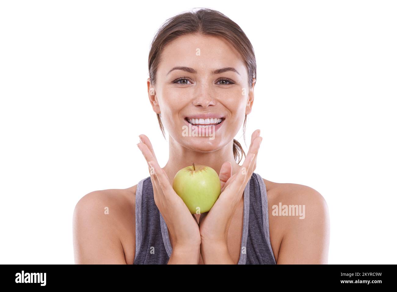 Making healthy choices. A young woman in gymwear holding an apple and ...