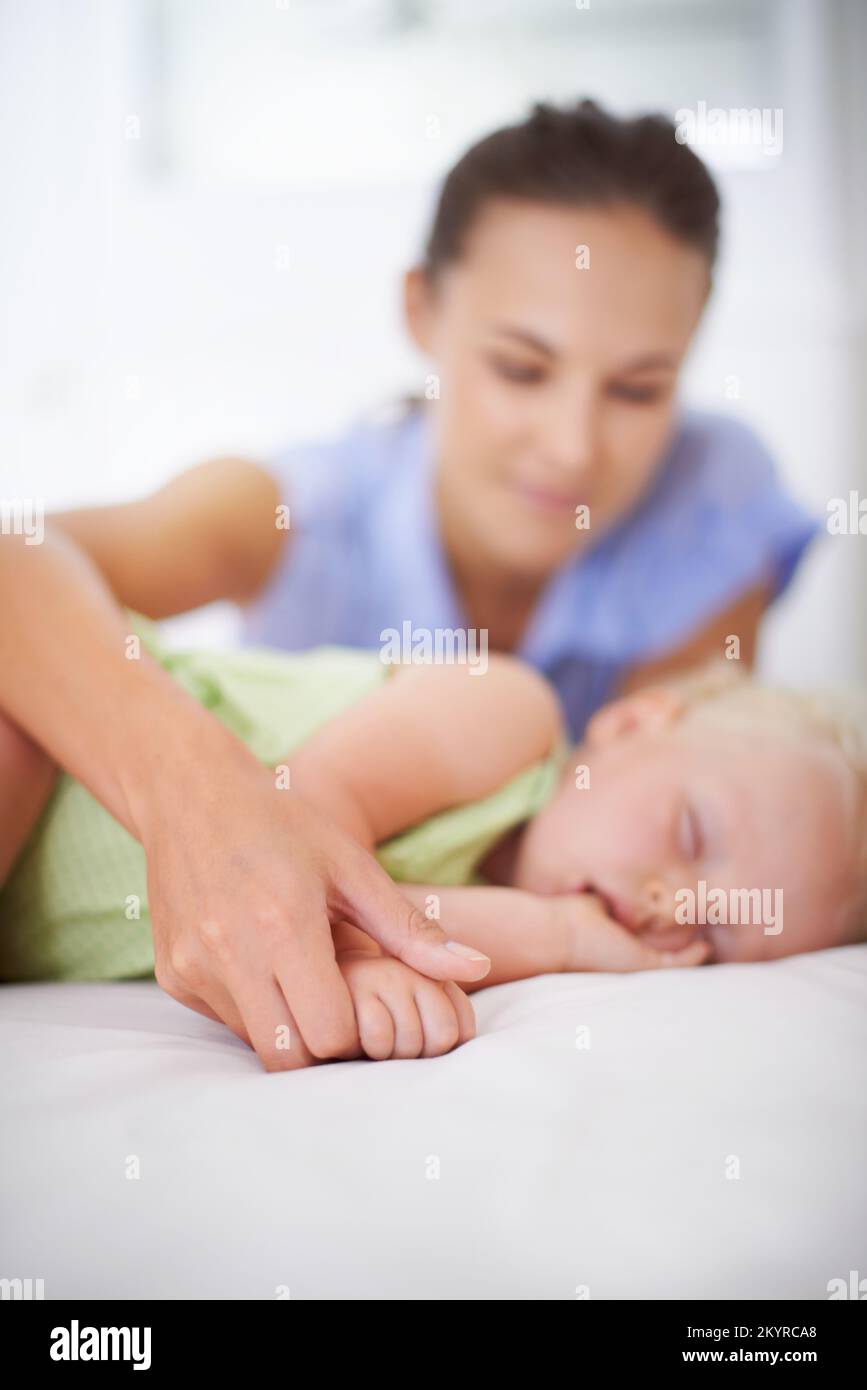 Sleeping little angel. a mother watching over her sleeping child Stock ...