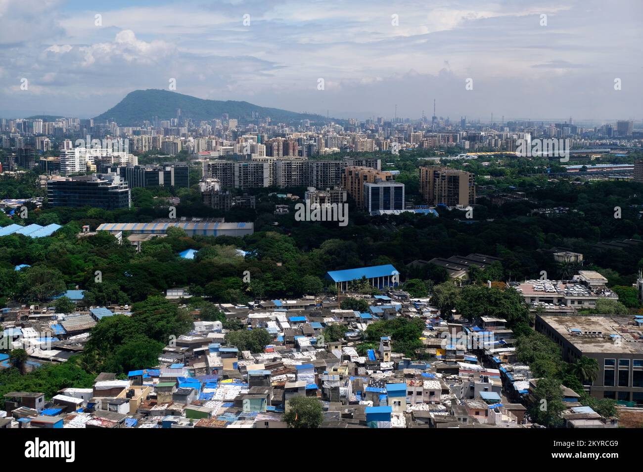 An aerial view of Mumbai's skyline passing over a building with roads ...
