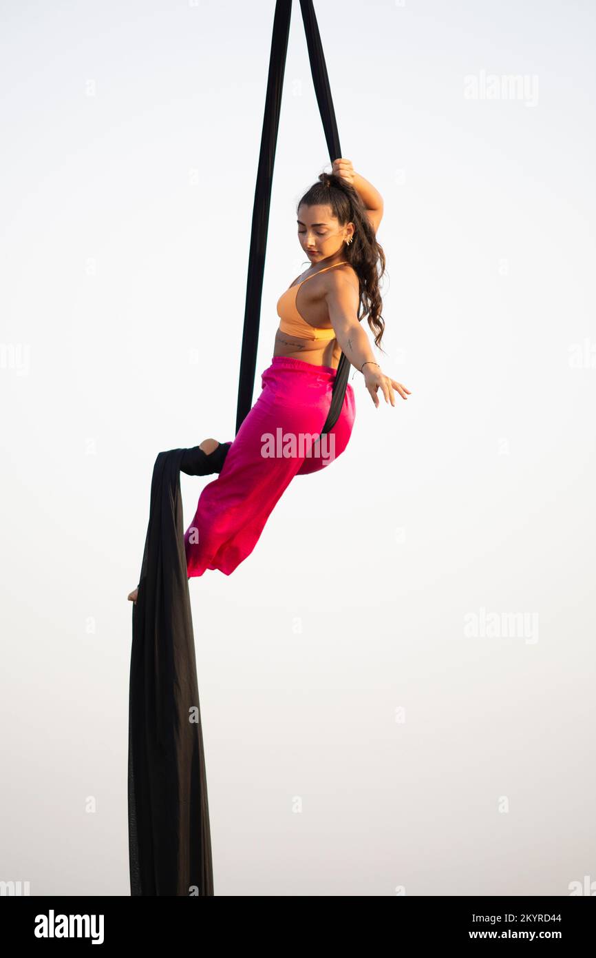 Young female aerialist performing on silk outdoors Stock Photo - Alamy