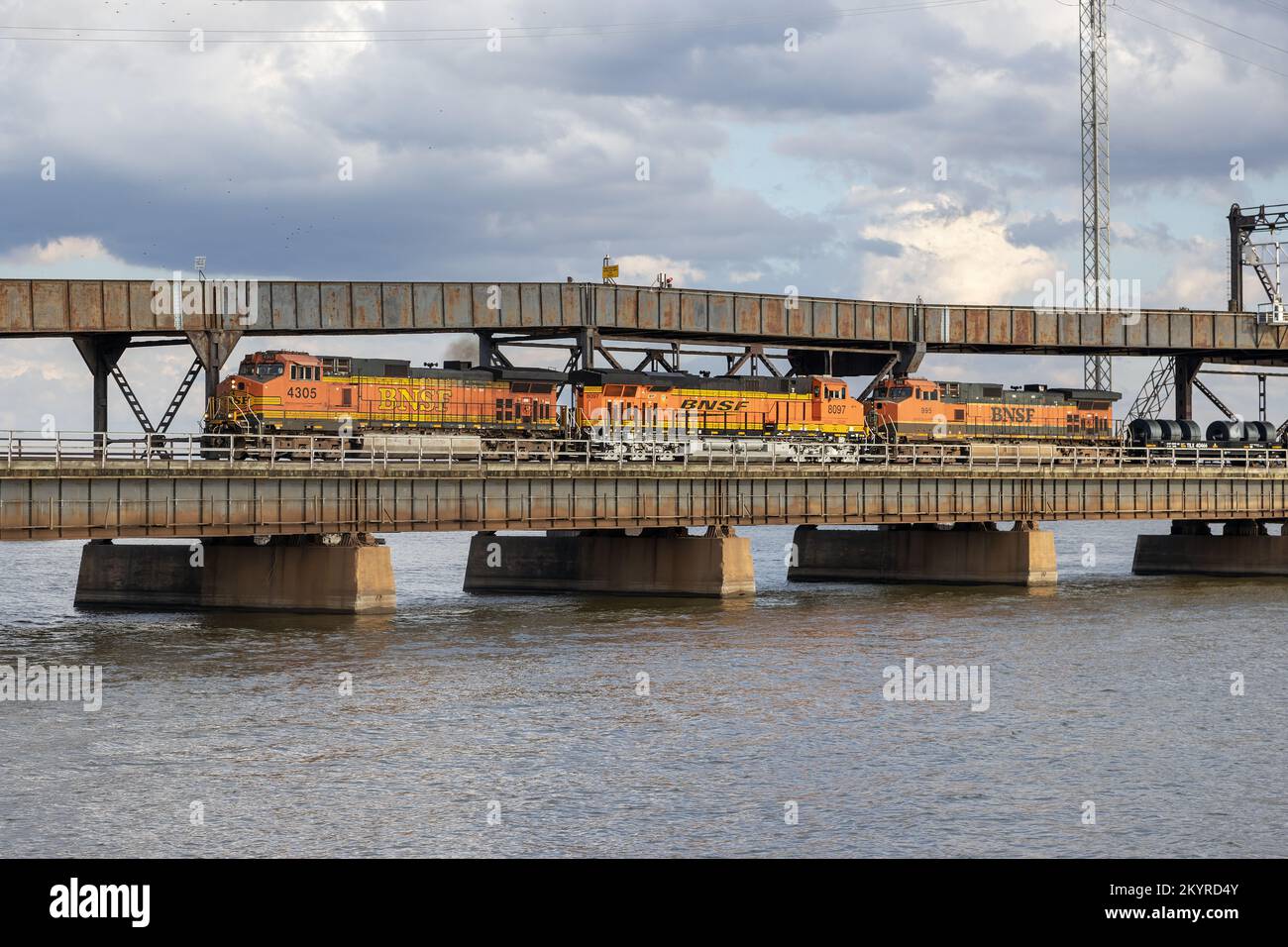 A westbound BNSF freight train crossing the Mississippi River on the Santa Fe Swing Span Bridge ...
