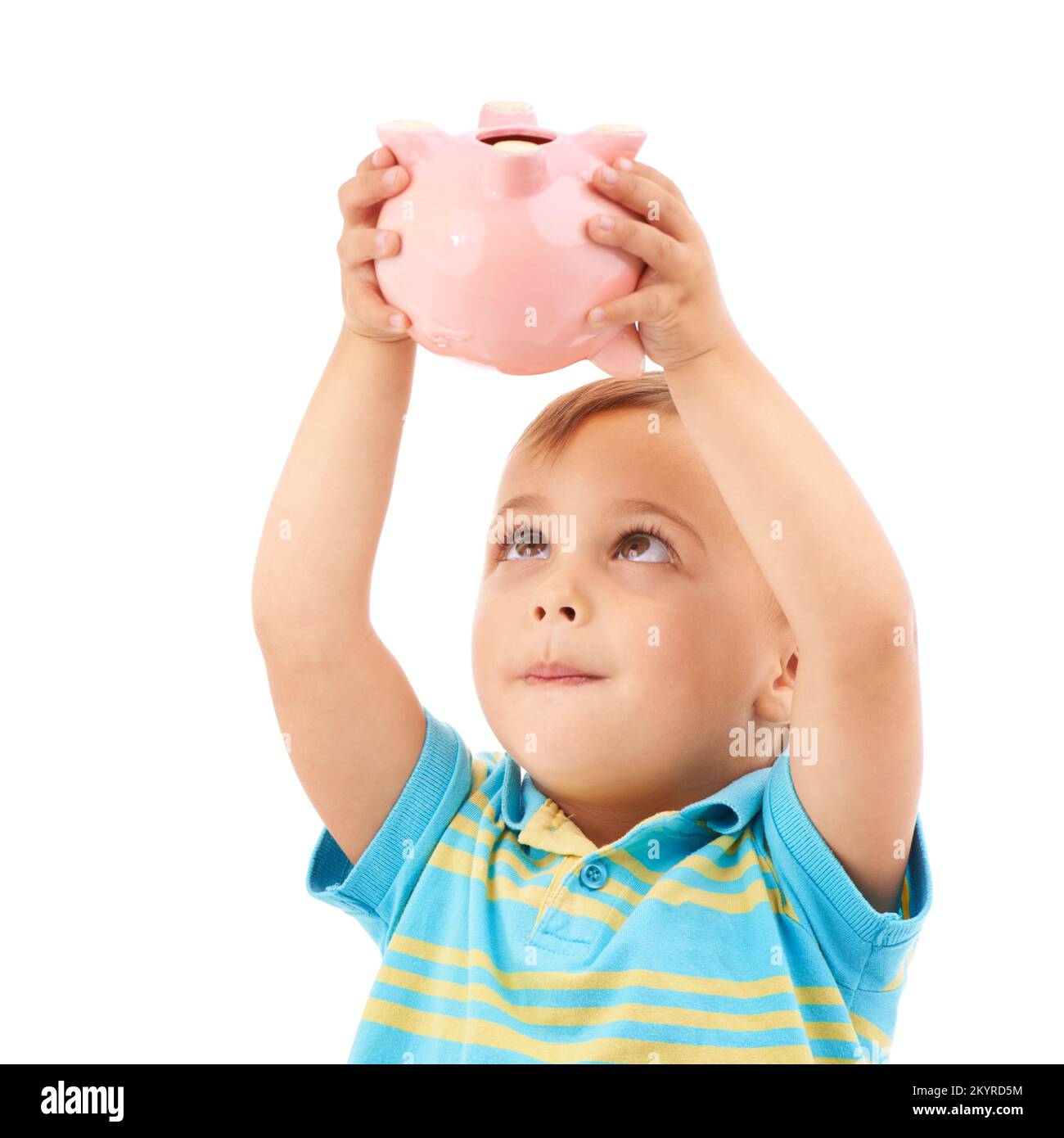 Good saving habits. Studio shot of a young boy holding up a piggy bank ...