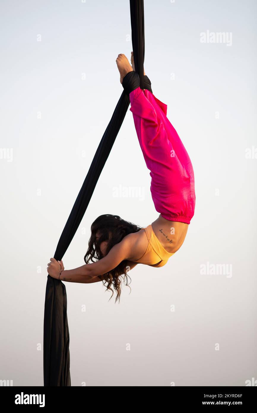 Young female aerialist performing on silk outdoors Stock Photo - Alamy
