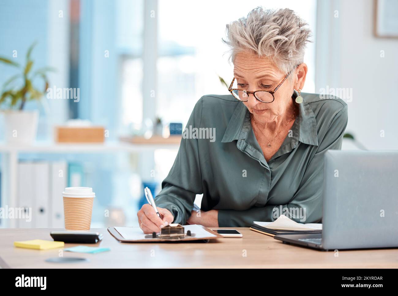 Senior, contract and business woman sign a legal document in a office ...