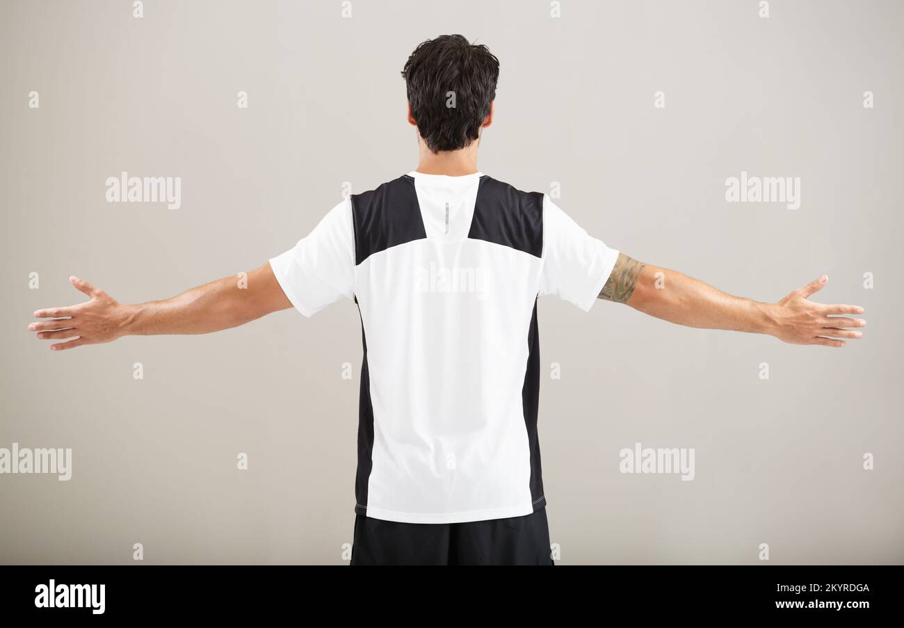 Getting behind freedom. Rearview of a young man standing with his arms ...