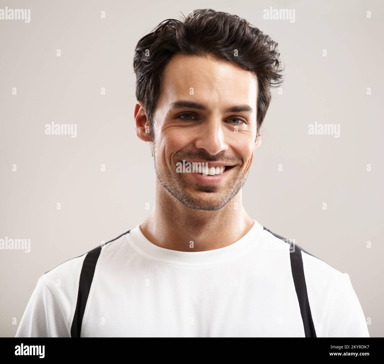 Giving you a charming smile. Portrait of a handsome young man giving ...